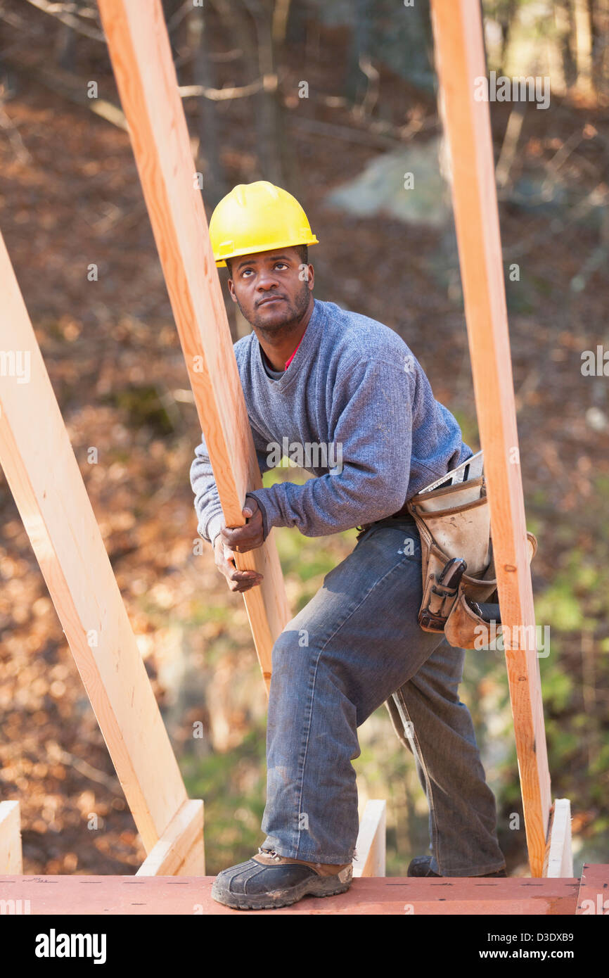 Carpenter placing a rafter Stock Photo - Alamy