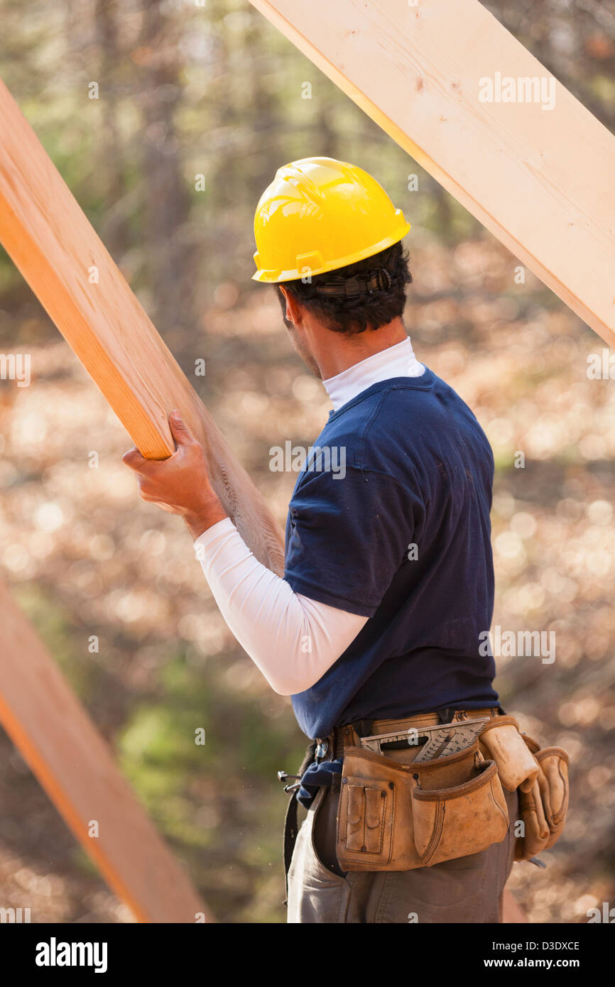 Carpenter placing a rafter Stock Photo - Alamy