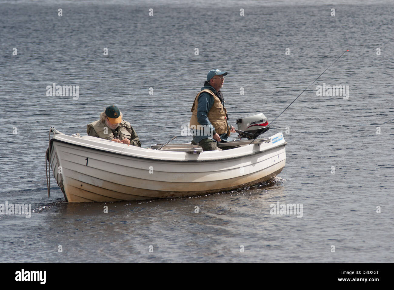 Two men fishing on a reservoir in a fishing boat Stock Photo - Alamy