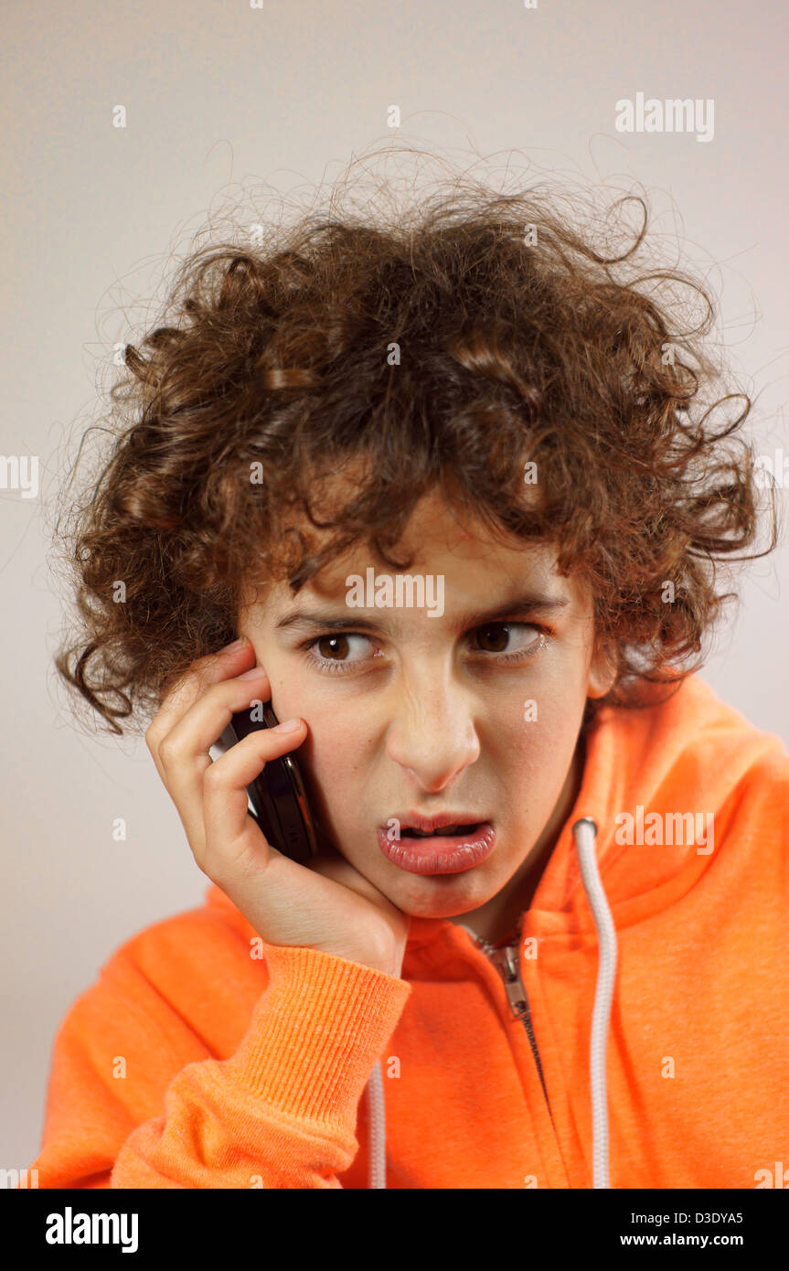 Young boy is talking on the phone Stock Photo - Alamy