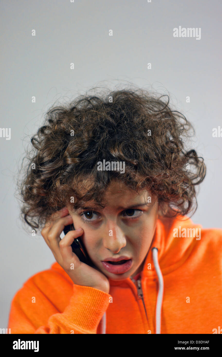Young boy is talking on the phone Stock Photo - Alamy