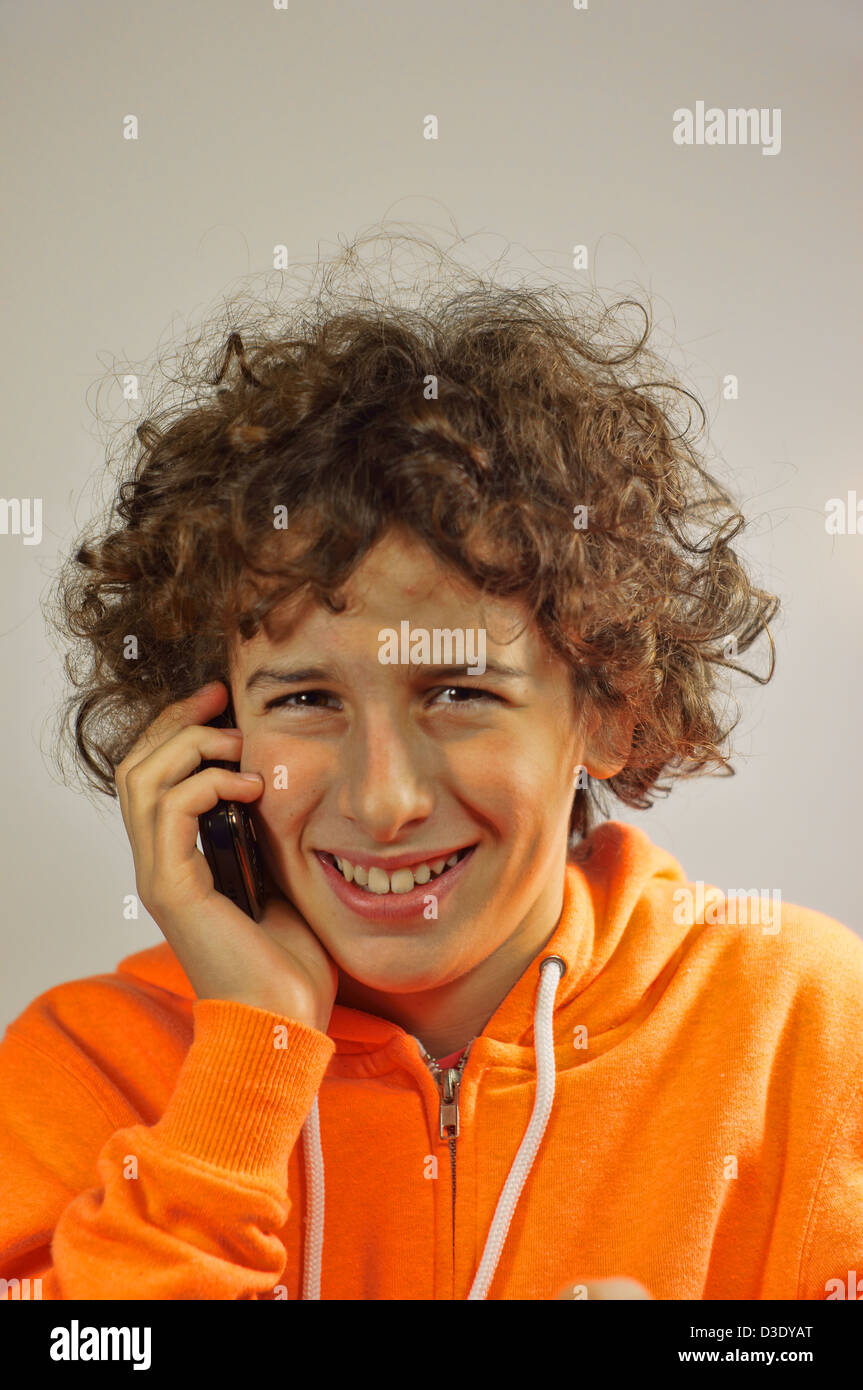 Young boy is talking on the phone Stock Photo - Alamy