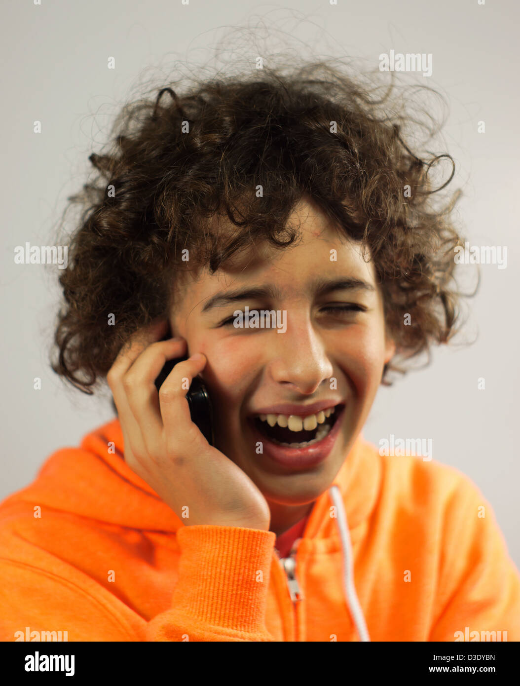 Young boy is talking on the phone Stock Photo - Alamy