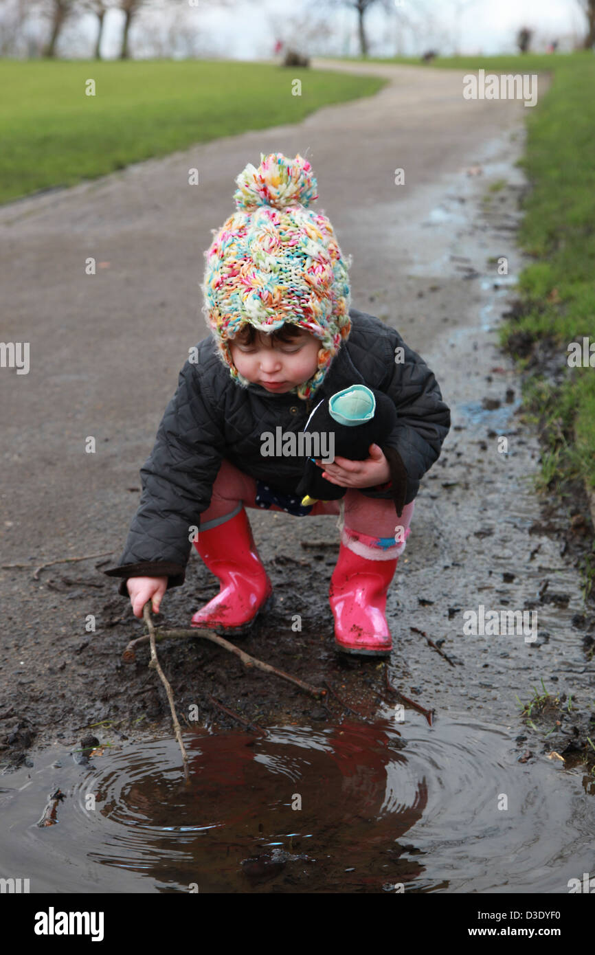 Toddler playing in a puddle Stock Photo - Alamy