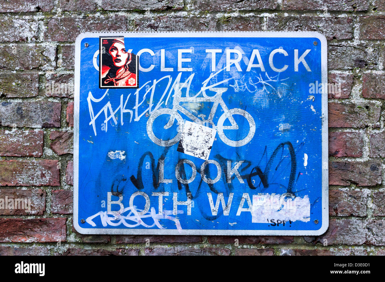 Graffiti covered cycle track sign Stock Photo - Alamy