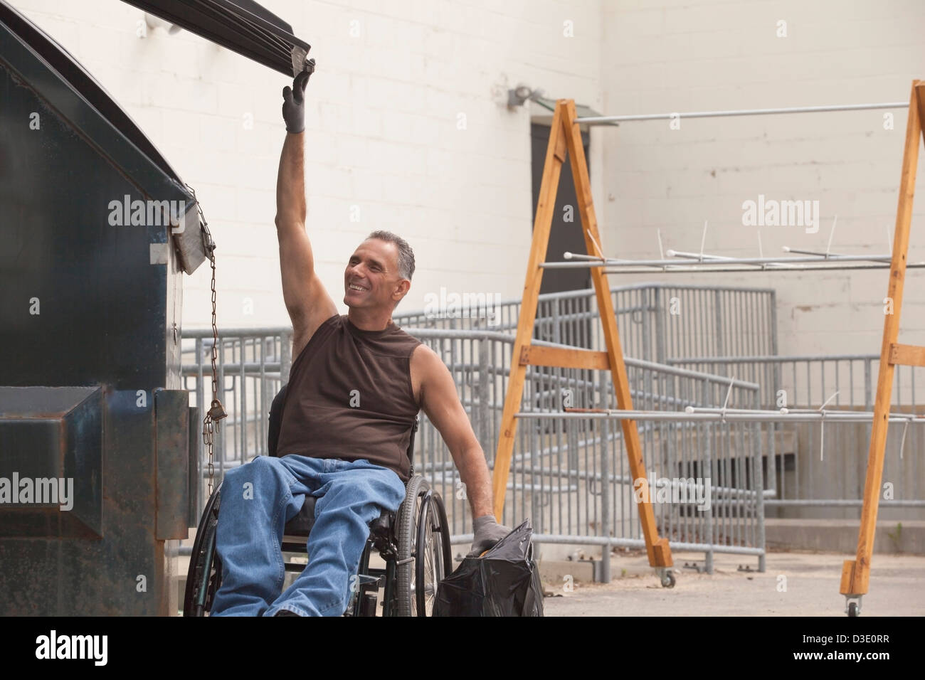 Loading dock worker with spinal cord injury in a wheelchair putting a ...