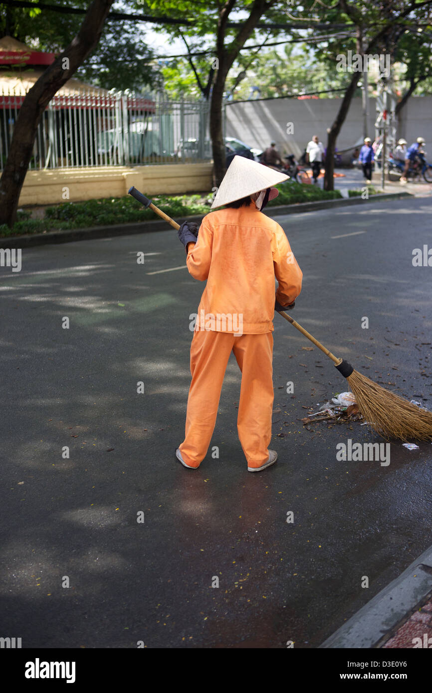Street cleaning woman with cone hat . Ho Chi Minh City, Vietnam Stock ...