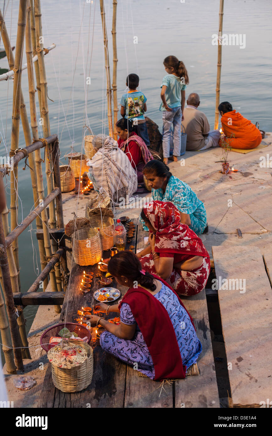 Indian women praying praying at dusk, Varanasi, India Stock Photo - Alamy