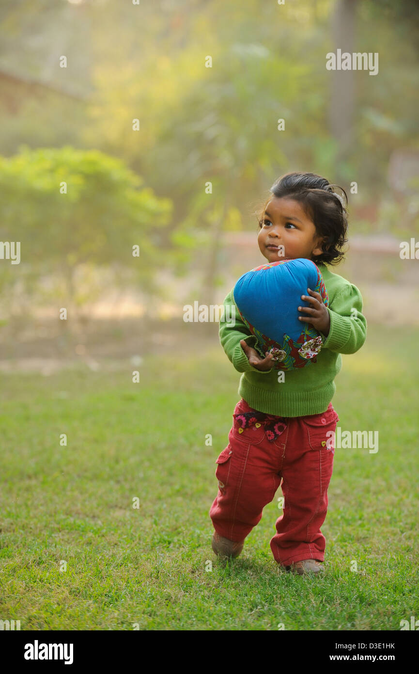 Indian baby girl playing in a garden Stock Photo - Alamy