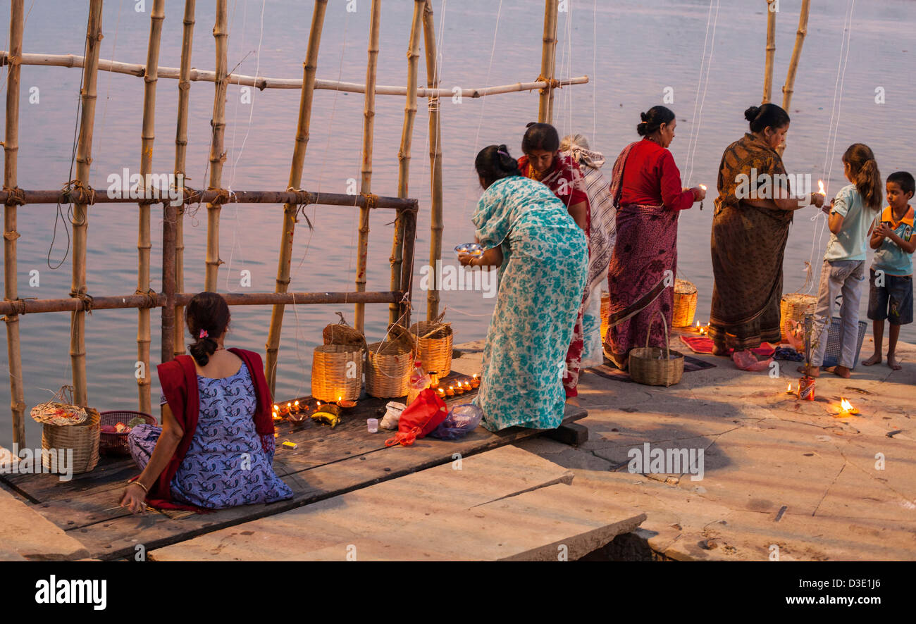 Indian women praying praying at dusk, Varanasi, India Stock Photo - Alamy