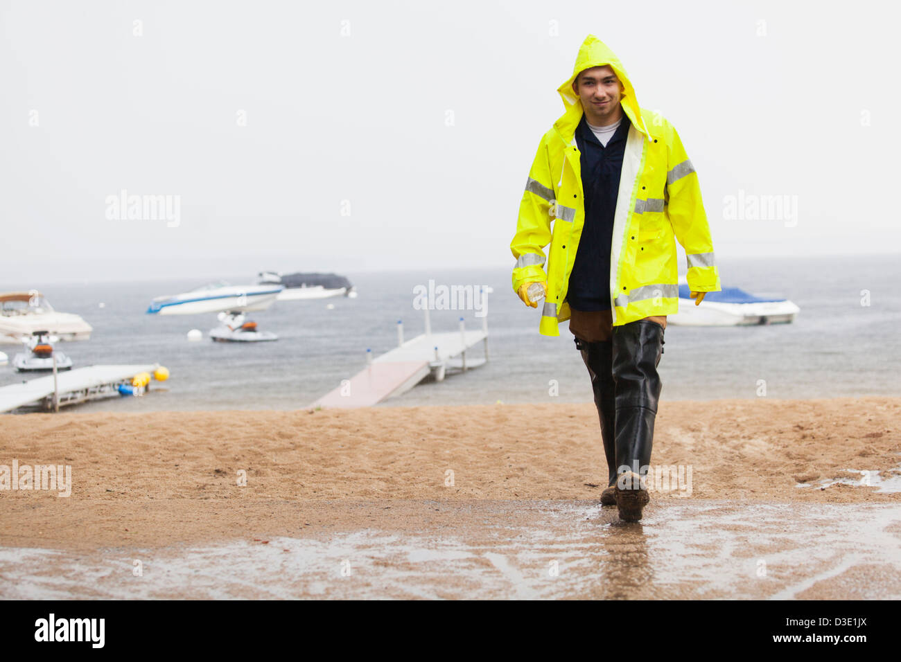 Public works engineer carrying water sample packet from lake, Portland ...