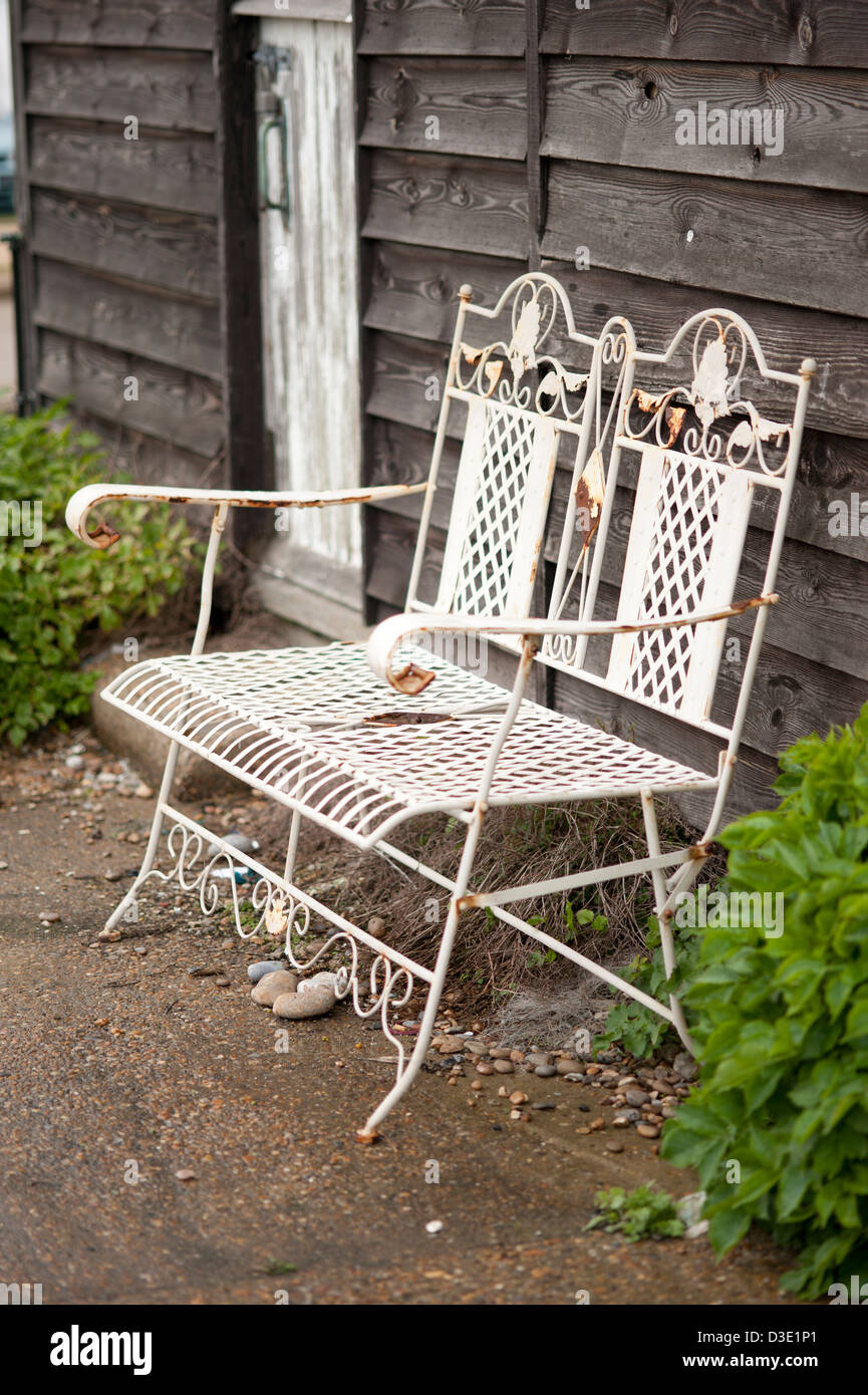 White Victorian rusty metal bench at the seaside Stock Photo - Alamy
