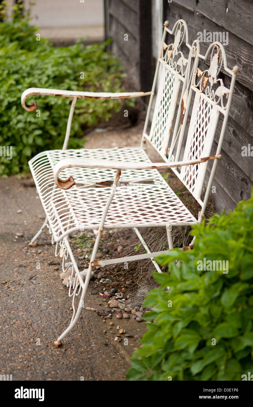 White Victorian rusty metal bench at the seaside Stock Photo - Alamy