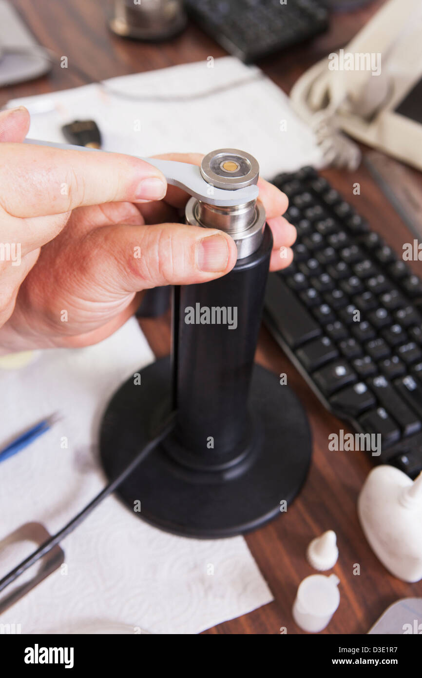Engineer putting on retaining ring in an O2 electrochemical sensor ...
