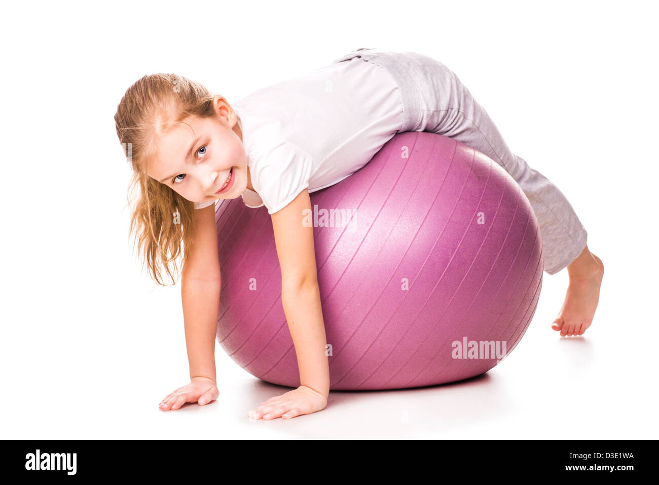 Sportive girl on a fit ball jumping isolated on white Stock Photo - Alamy