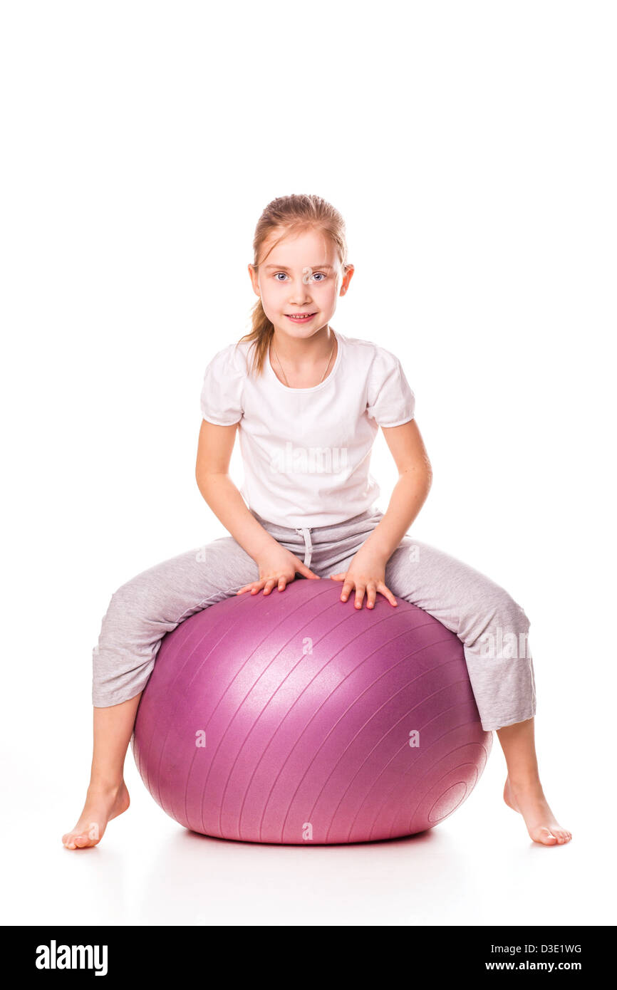 Sportive girl on a fit ball jumping isolated on white Stock Photo - Alamy