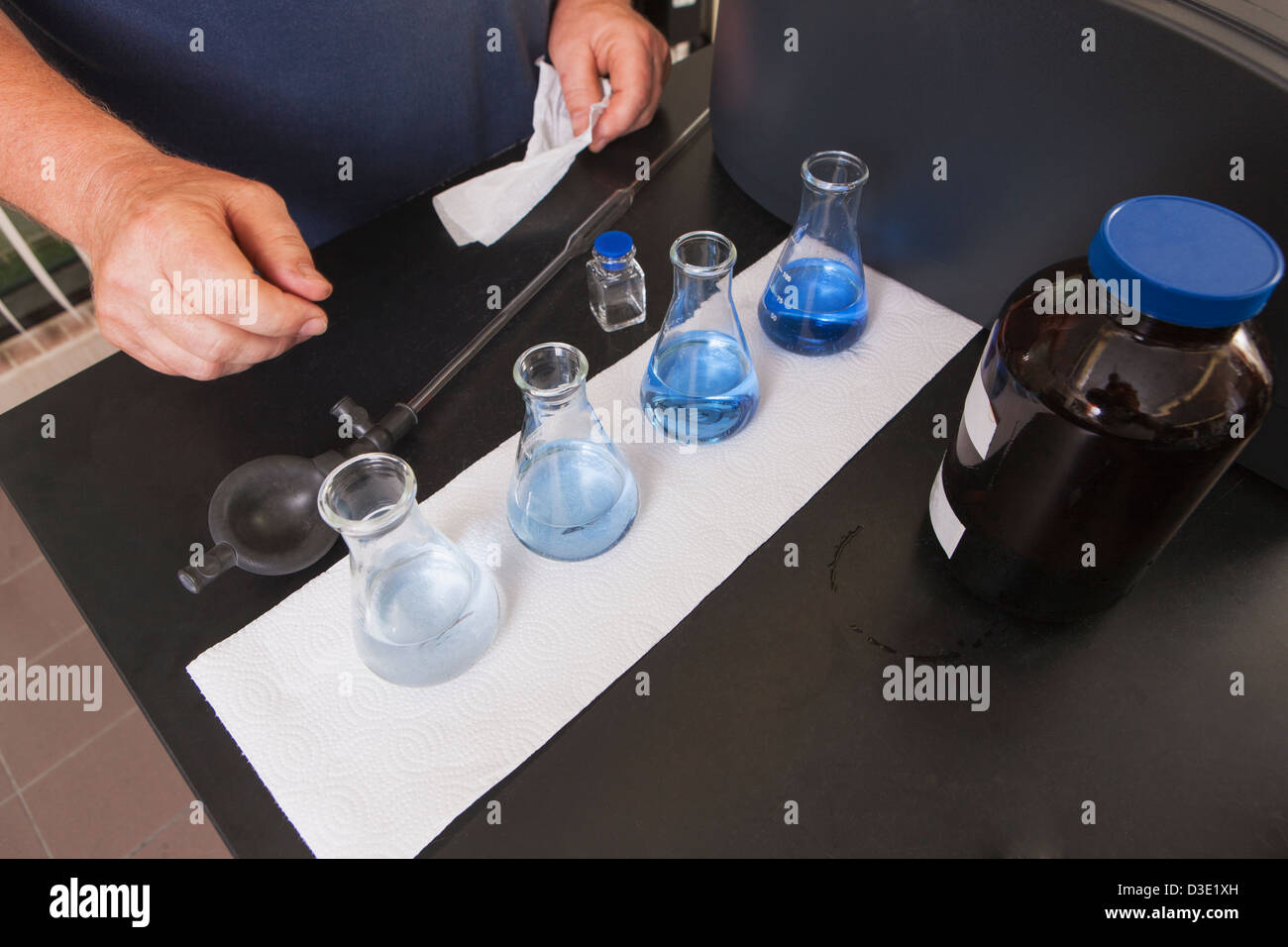 Bottles of indigo solution with ozonated water in water treatment plant ...