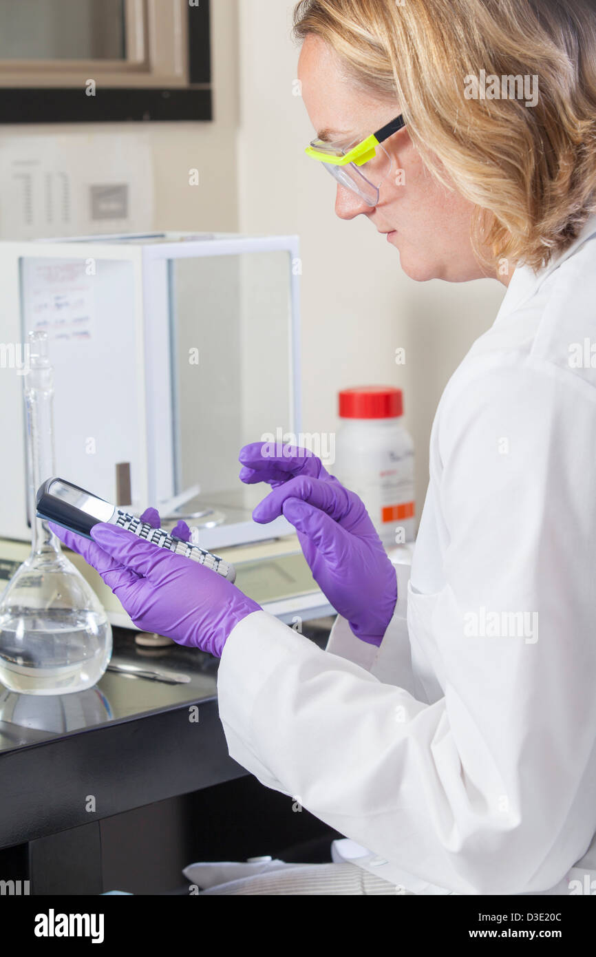 Laboratory scientist doing calculations for chemical analysis Stock ...