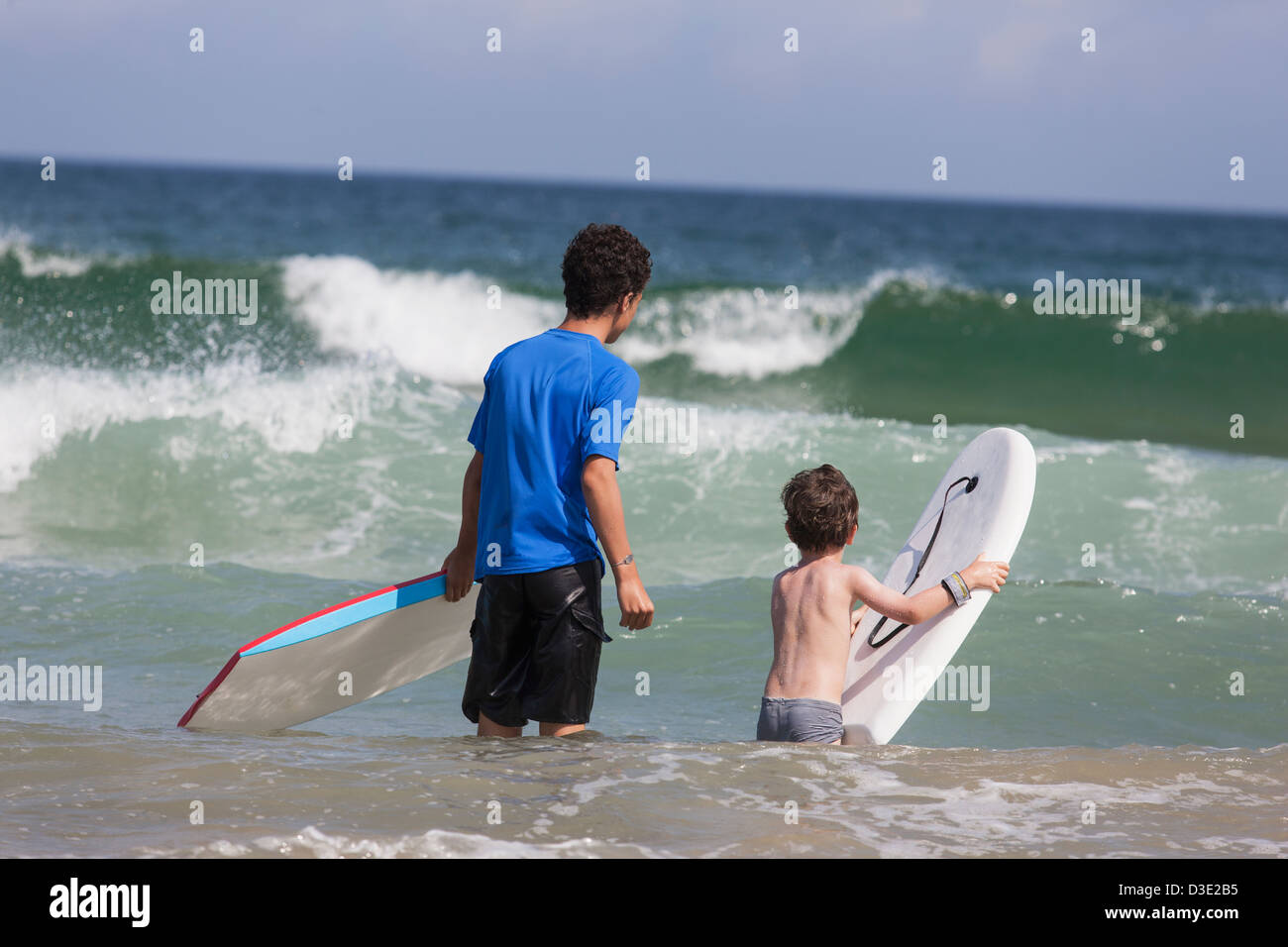 Two brothers surfing in the Atlantic ocean, Block Island, Rhode Island ...