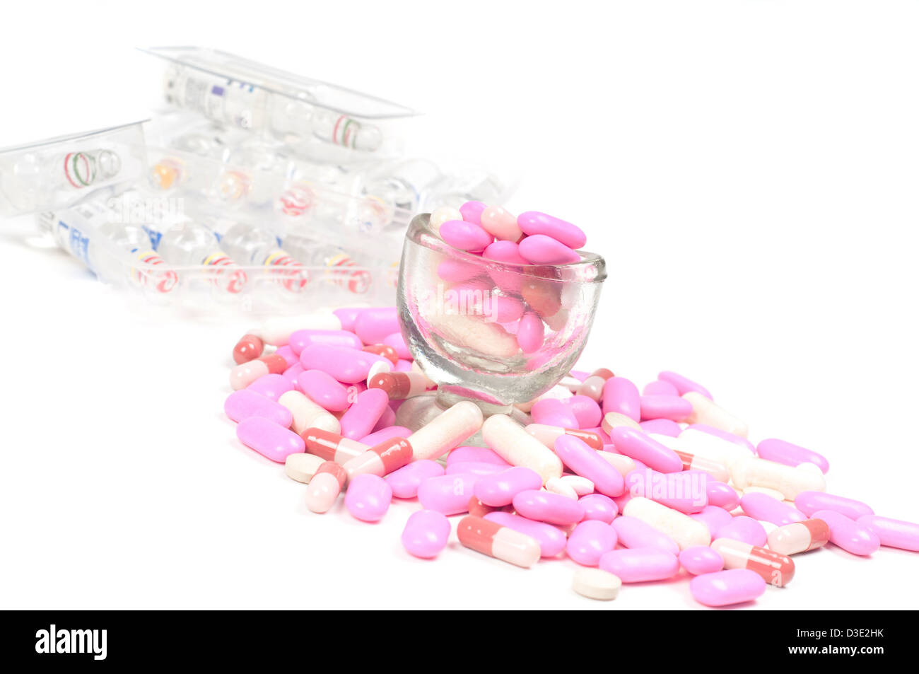 Shot of pink drugs (tablets) isolated on white Stock Photo - Alamy