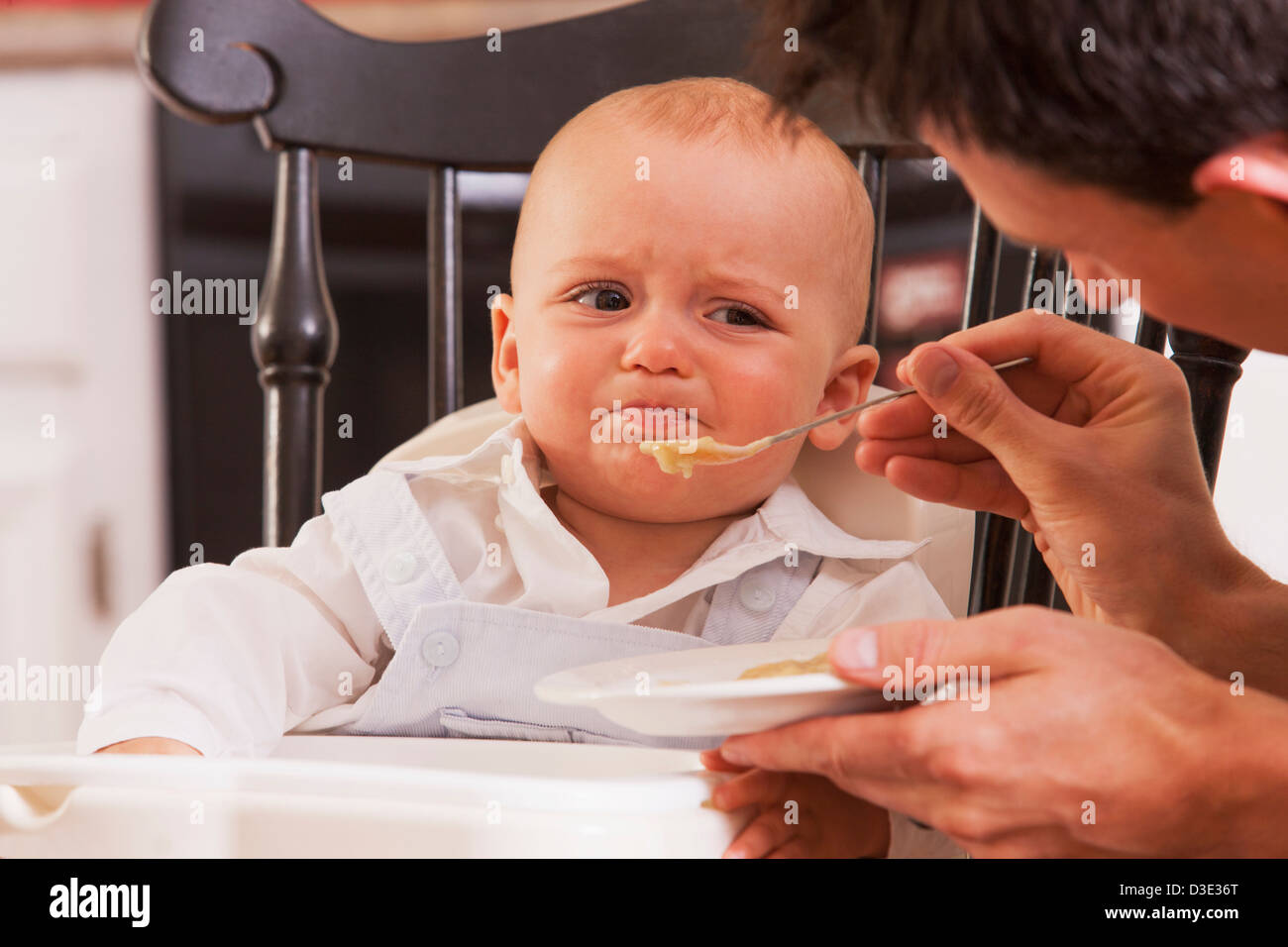 Father feeding food to his son who is refusing to eat Stock Photo - Alamy
