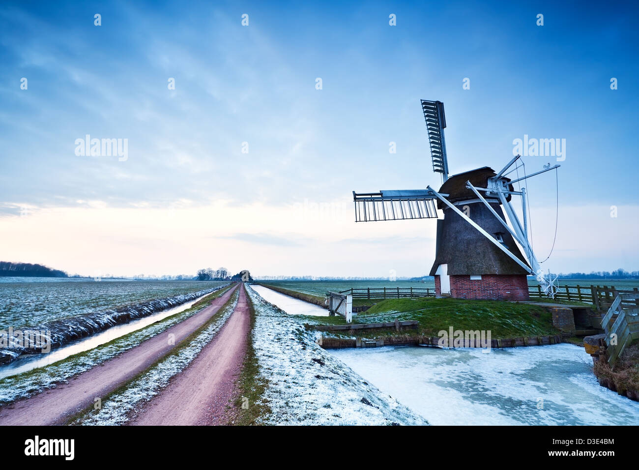 Dutch windmill during winter in dusk Stock Photo - Alamy