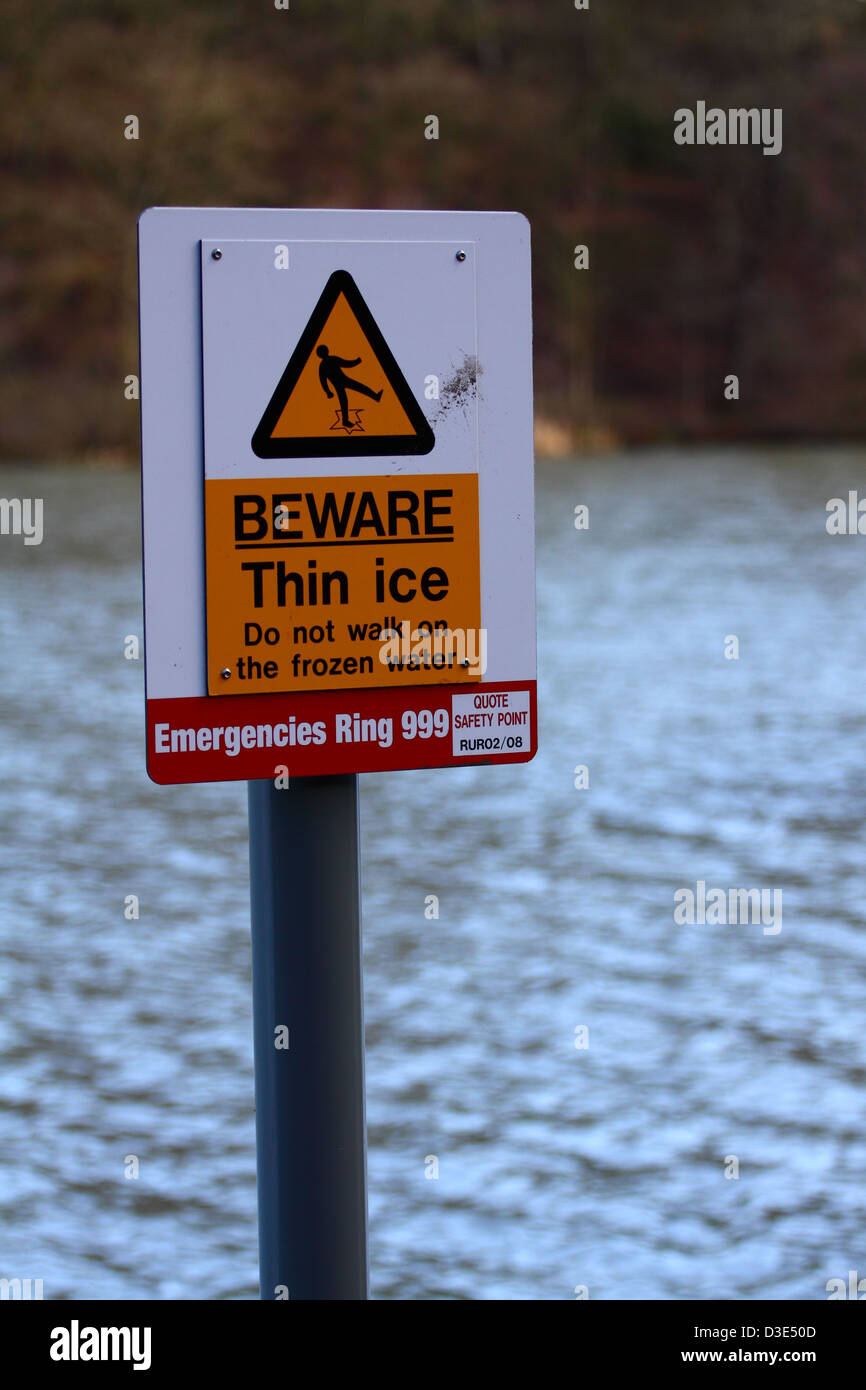 Beware thin ice sign post Stock Photo - Alamy