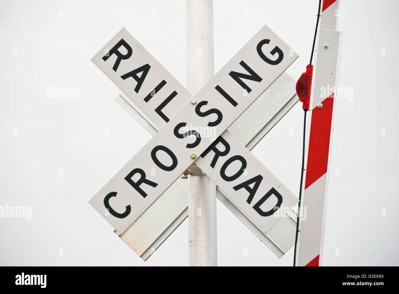 Railroad crossing sign with gate up Stock Photo - Alamy