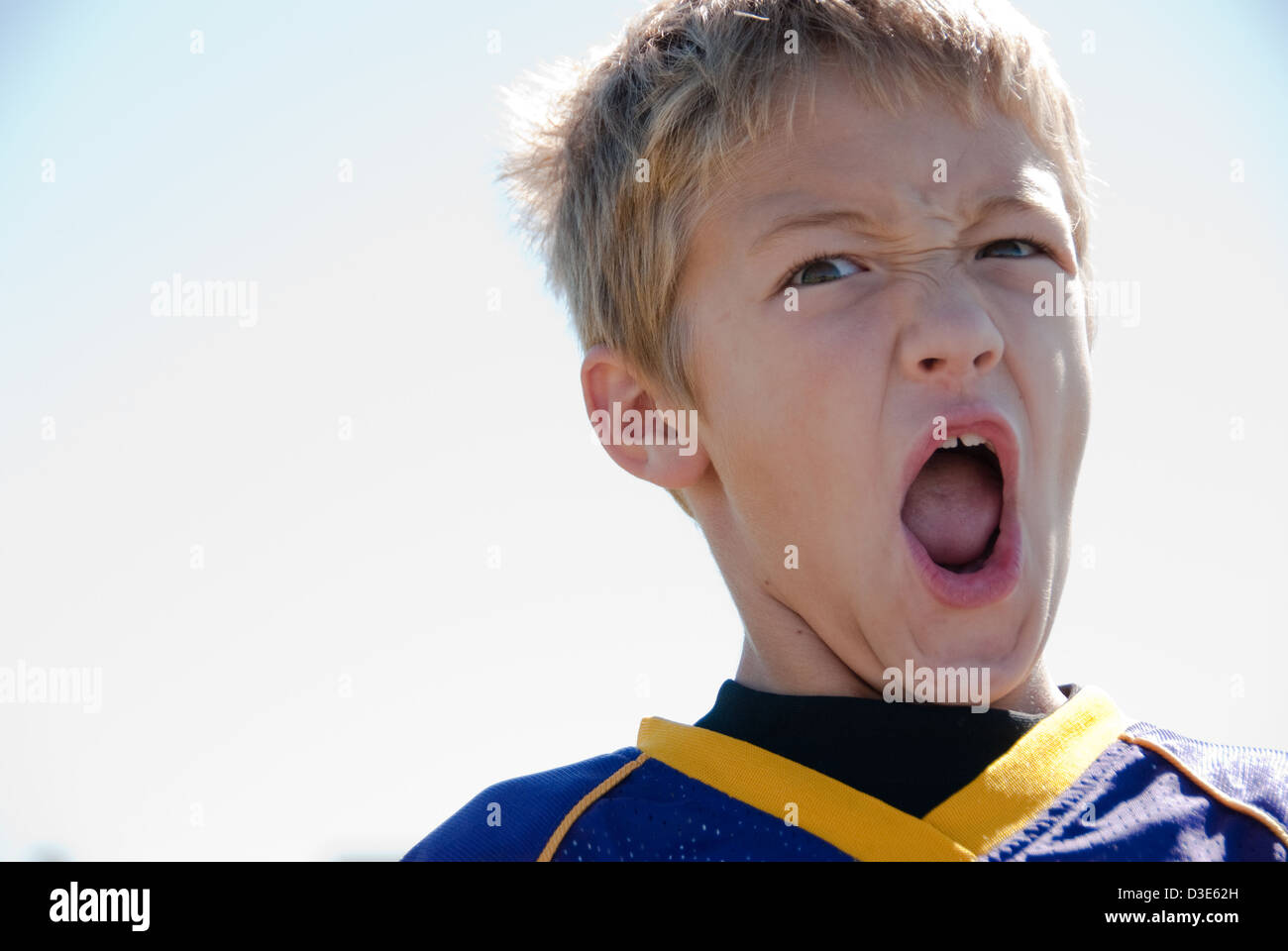 Young boy yelling during the game Stock Photo - Alamy