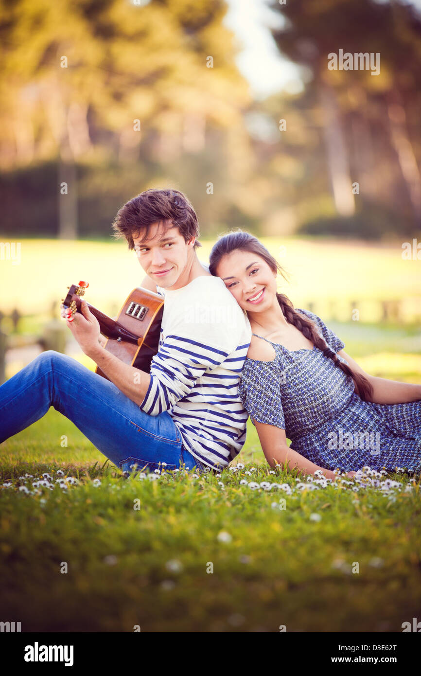 summer romance with guitar boy playing guitar for girl Stock Photo - Alamy