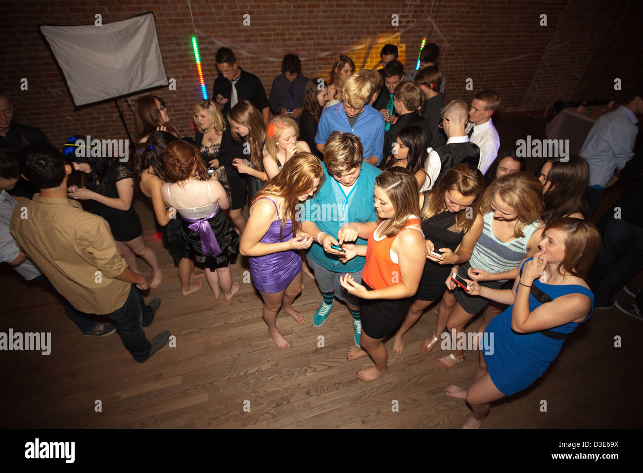 Group of teens at dance party staring at their phones, high angle view ...