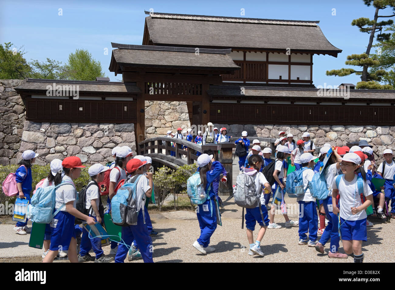 Elementary school children on outing crossing historic moat bridge at ...