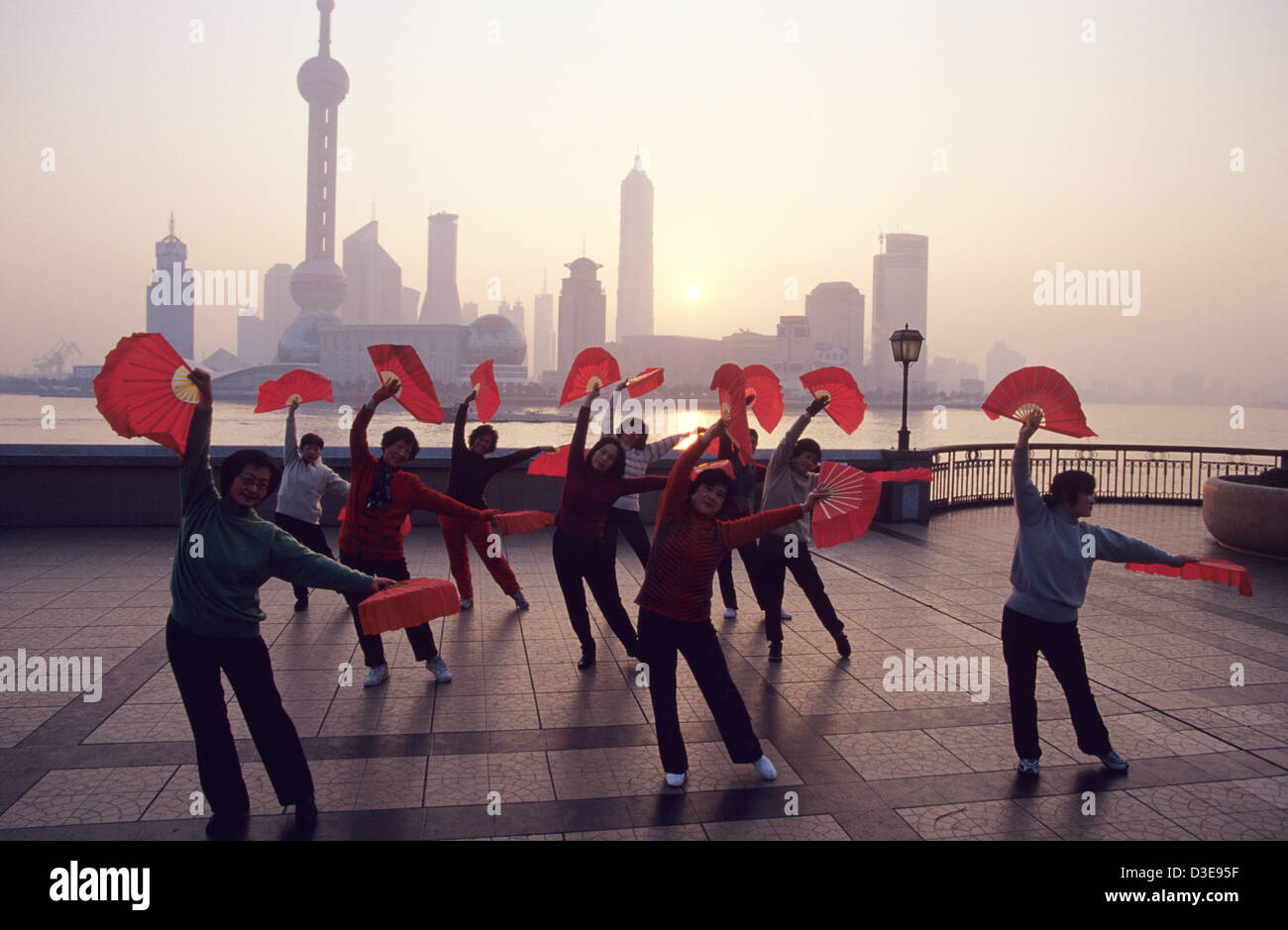 fan dancers do a traditional chinese dance for exercise at sunrise on ...