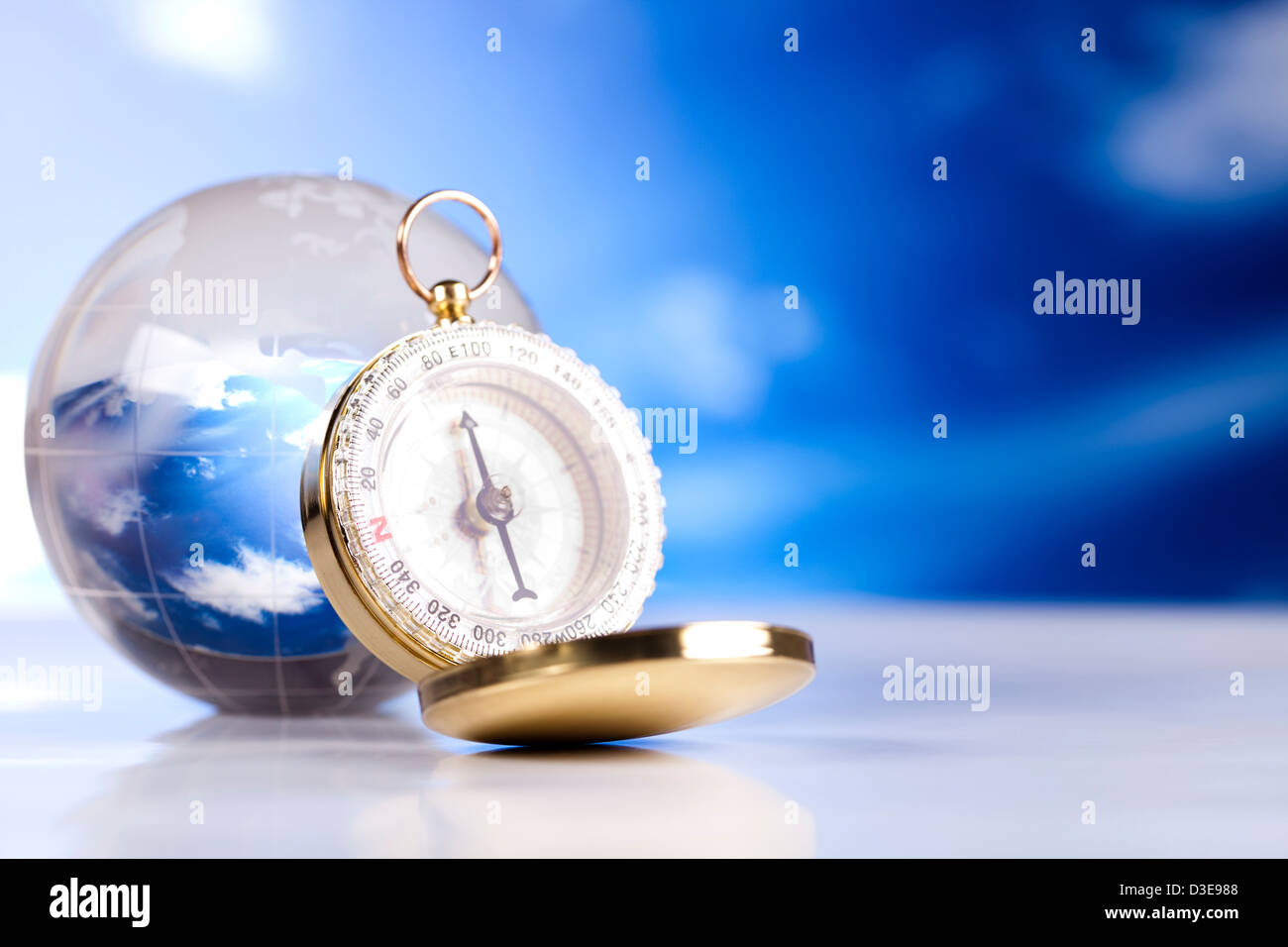 Compass, globe and sky Stock Photo - Alamy