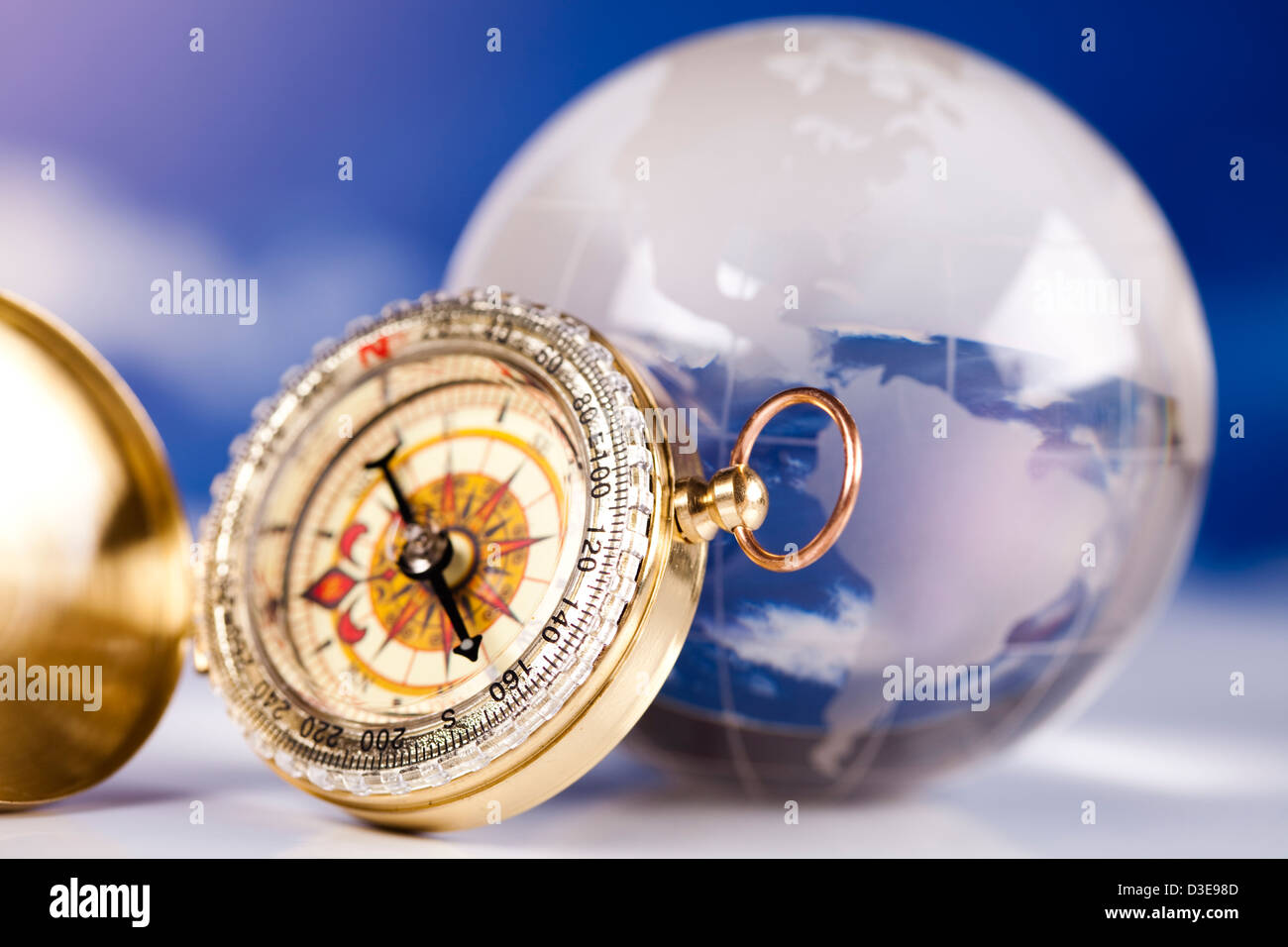 Compass, globe and sky Stock Photo - Alamy