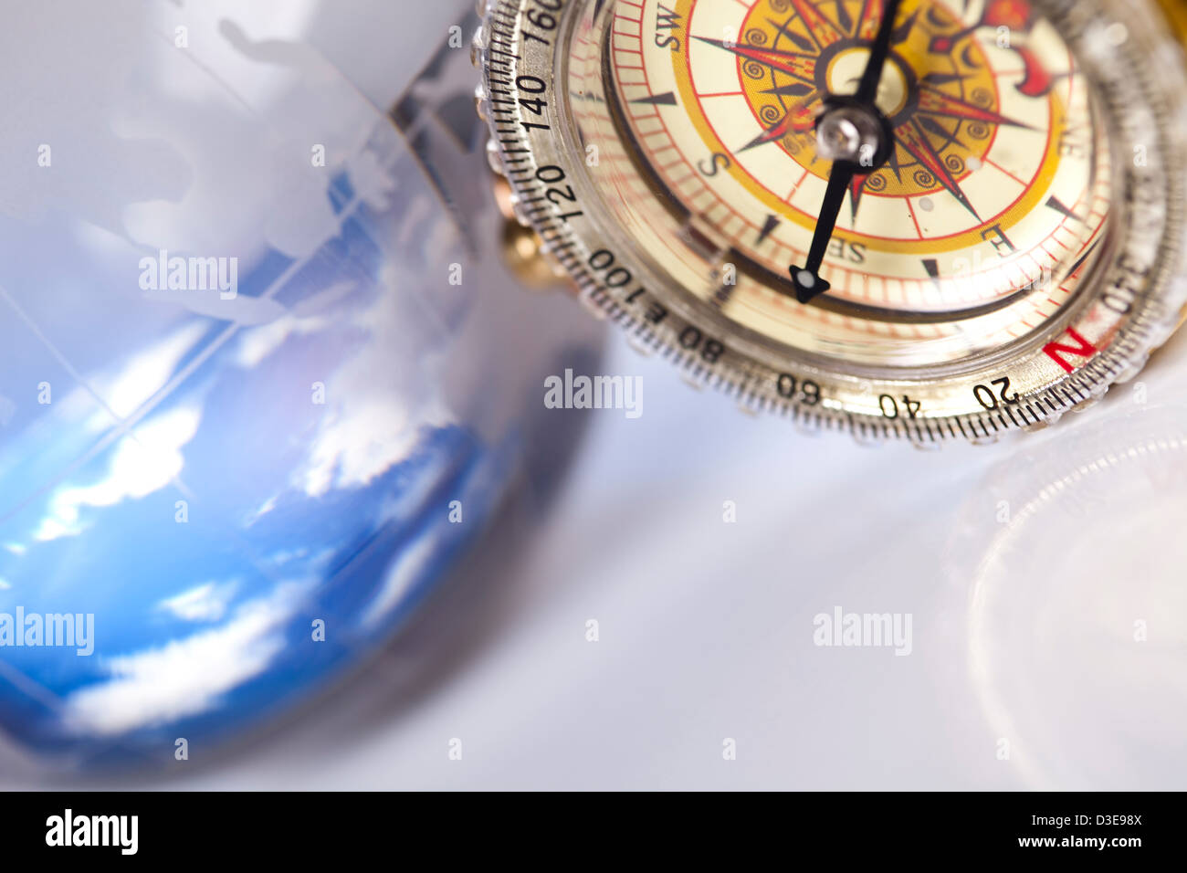 Compass, globe and sky Stock Photo - Alamy