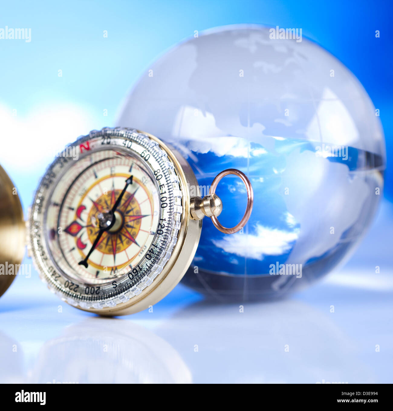 Compass, globe and sky Stock Photo - Alamy