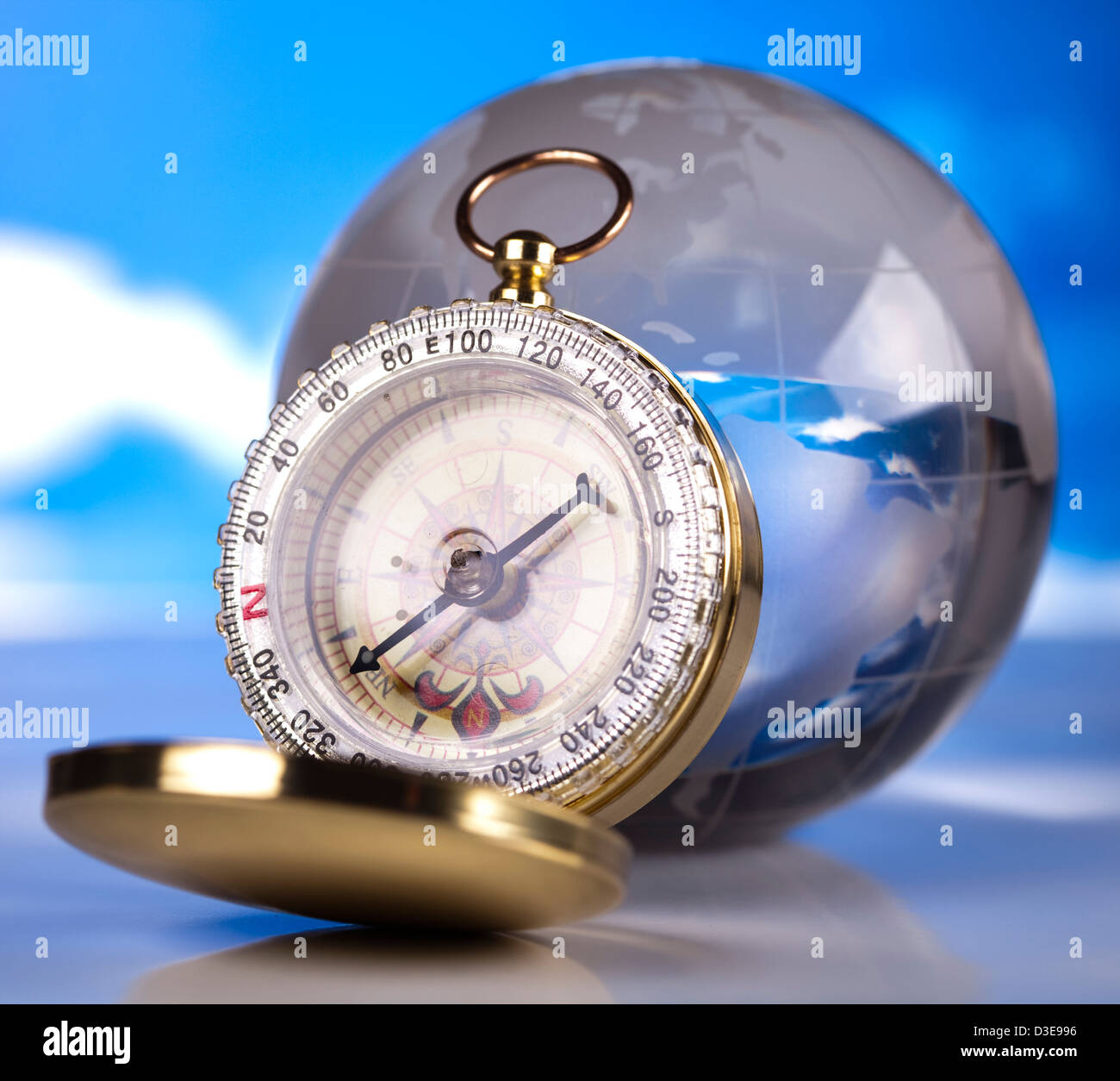 Compass, globe and sky Stock Photo - Alamy