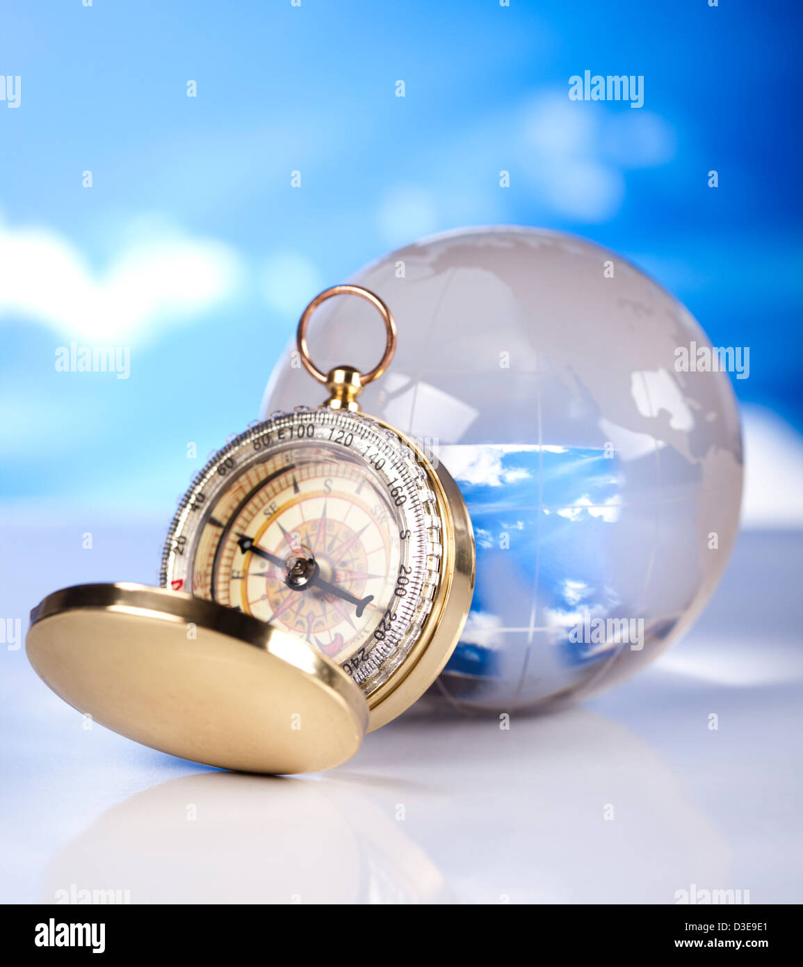 Compass, globe and sky Stock Photo - Alamy
