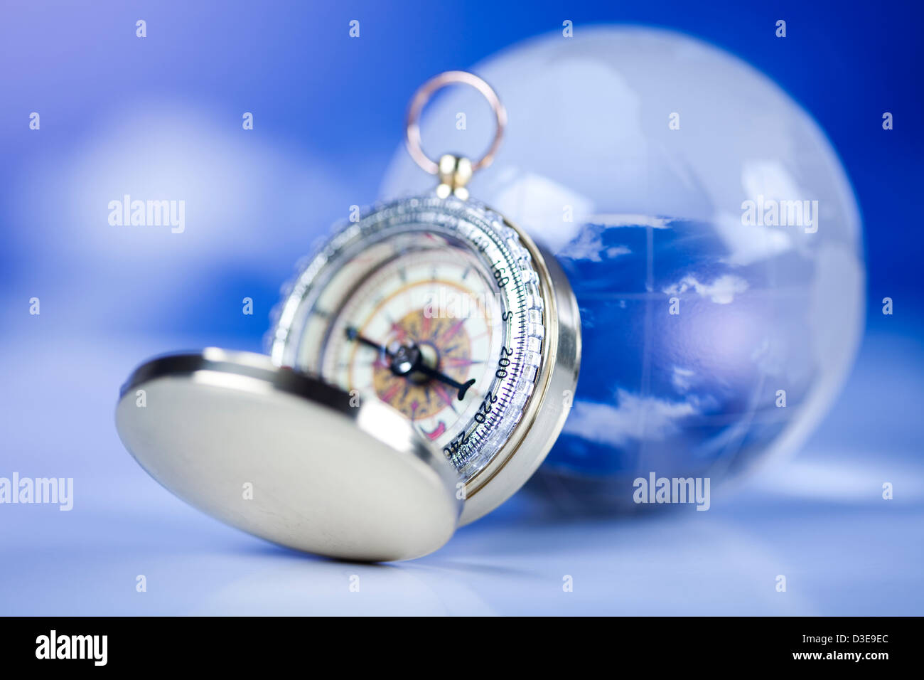 Compass, globe and sky Stock Photo - Alamy
