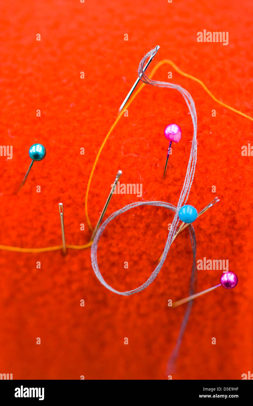 Pins and needls in red pin cushion Stock Photo - Alamy