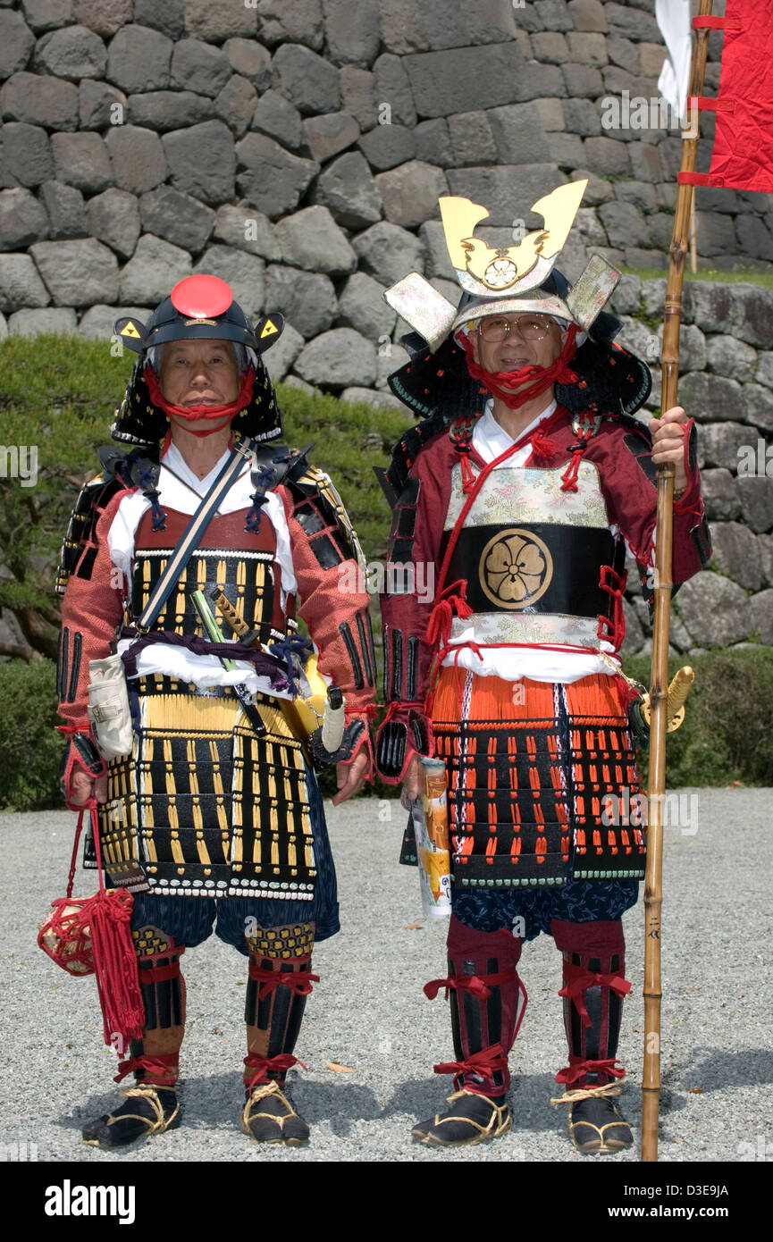 Two elderly Sunday samurai warriors wearing a traditional armor costume ...