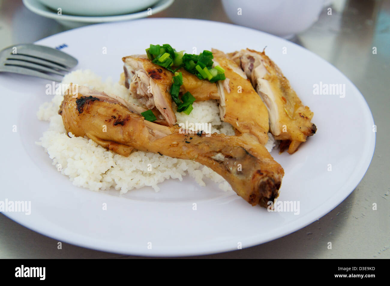 Grilled chicken leg over rice, Vietnamese food Stock Photo - Alamy