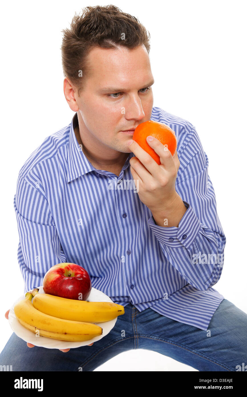 young man with fruits on white background concept of healthy nutrition ...