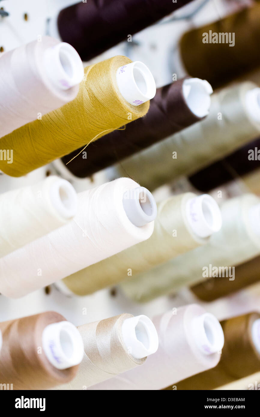 Colorful spools of thread on the wall in tailor shop Stock Photo - Alamy