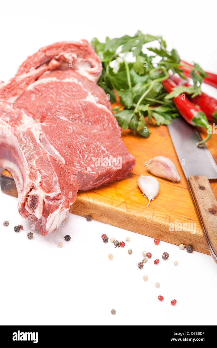 fresh meat of beef with bone on wooden with spices and knife Stock ...