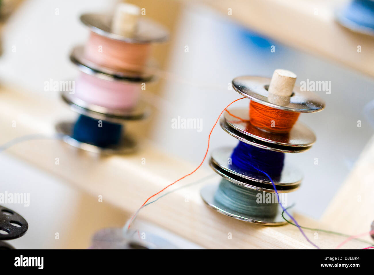 Colorful bobbins of thread on bobbin stand in tailor shop Stock Photo ...