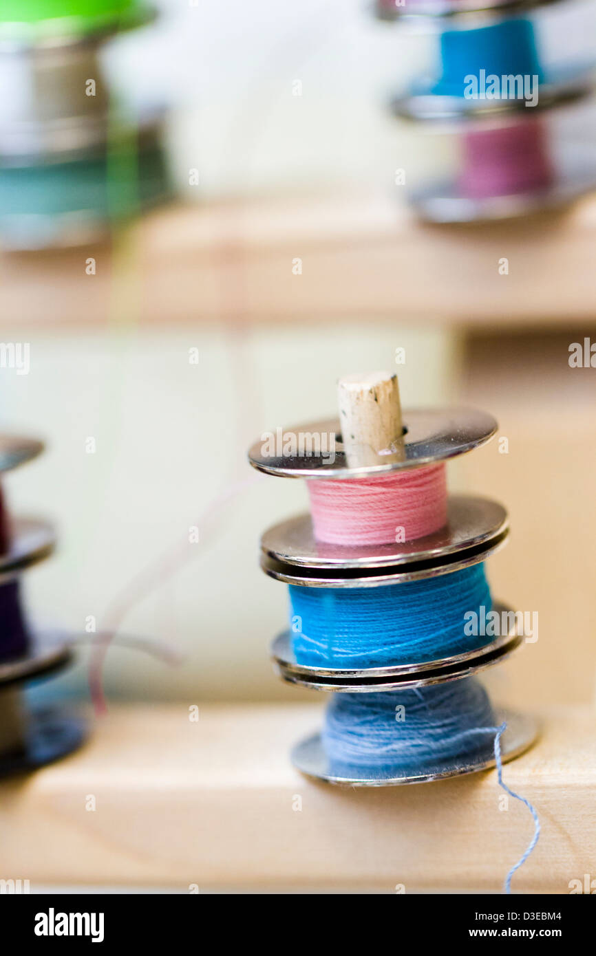 Colorful bobbins of thread on bobbin stand in tailor shop Stock Photo ...