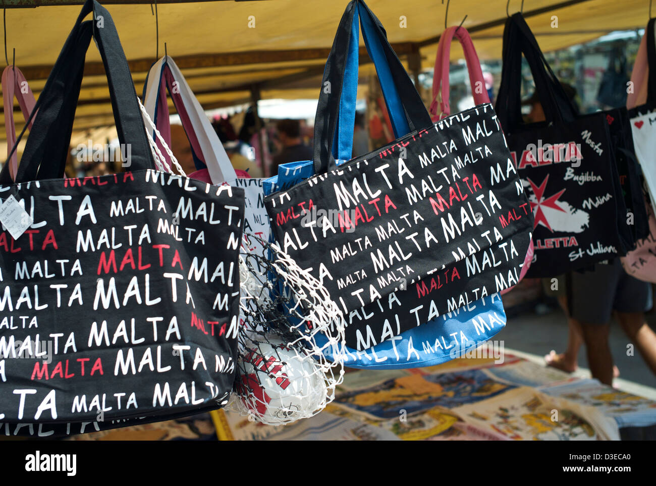 Shopping bags hanging in street market, Marsaxlokk Malta Stock Photo ...