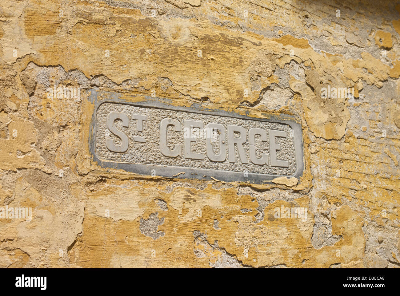 Street sign on textured stone wall Stock Photo - Alamy